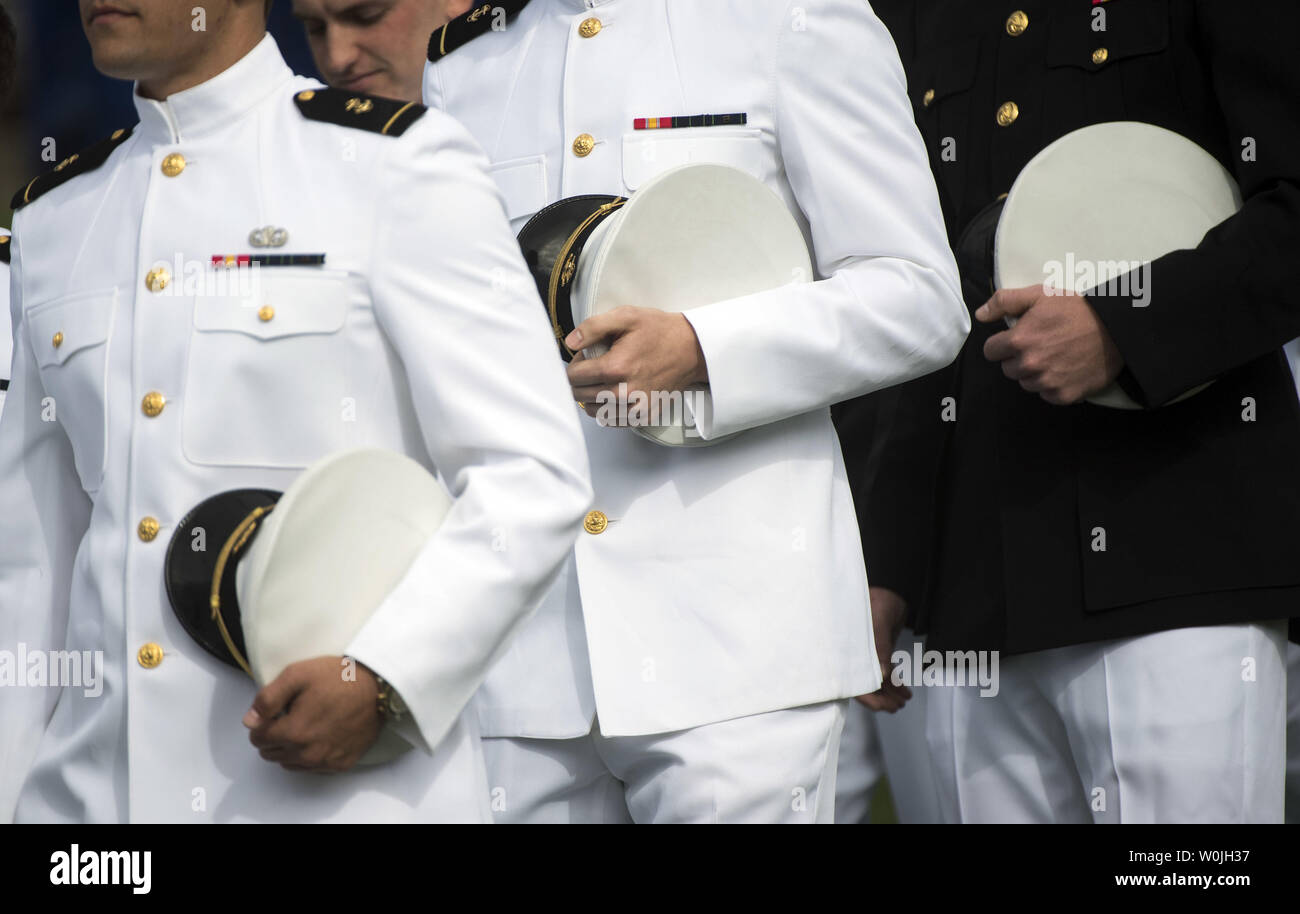 Graduating midshipmen hold their hats as they arrive for the Graduation ...