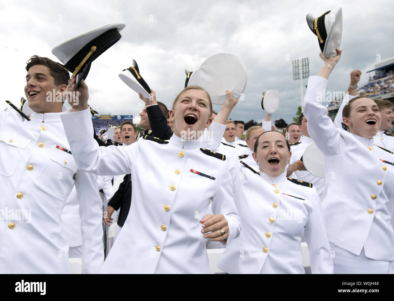 Graduating Midshipman cheer during the Graduation and Commissioning ...