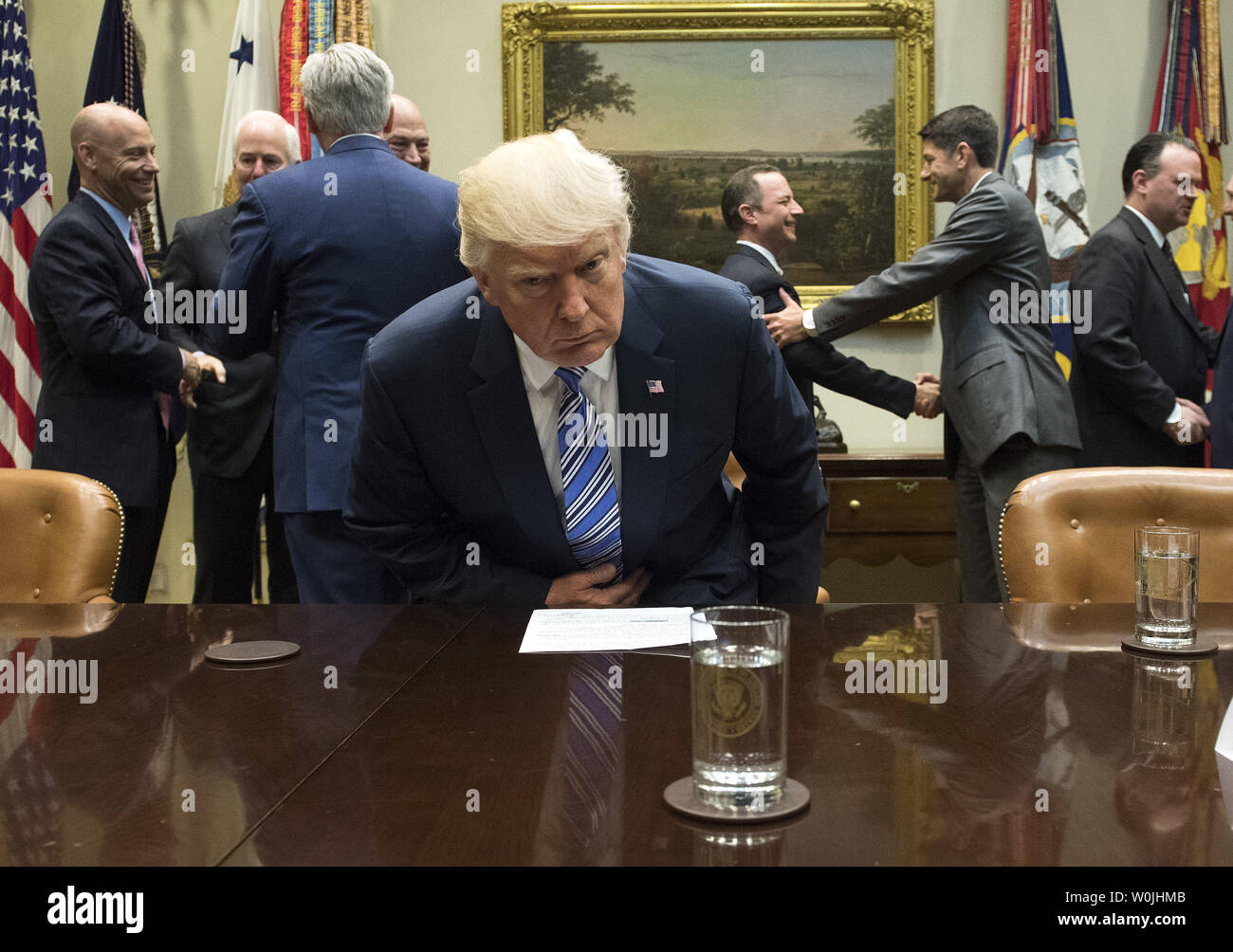 President Donald Trump sits at the start of a meeting with ...