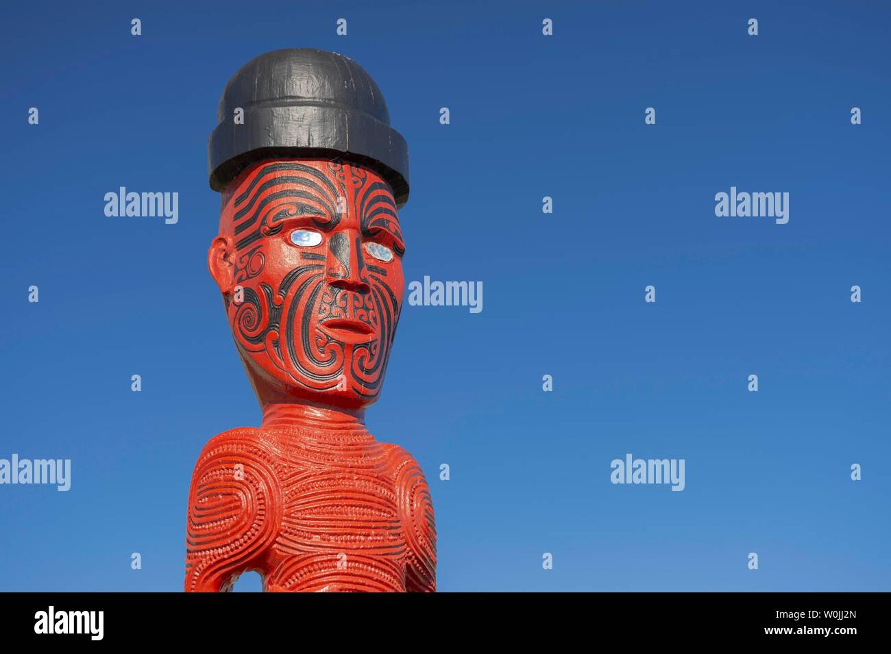 Artfully carved traditional statue of Maori made of wood, Whakarewarewa ...