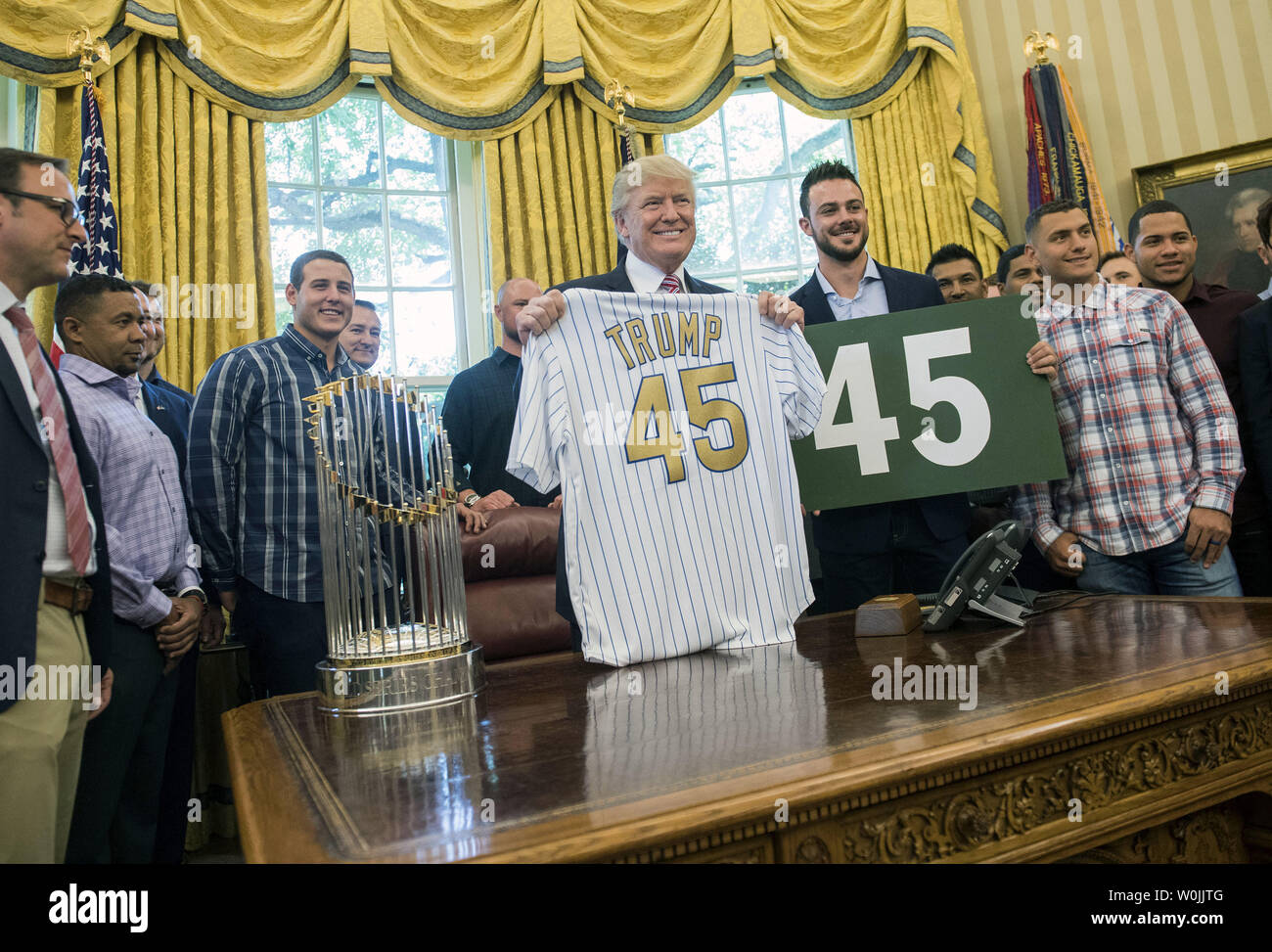 President Donald Trump holds a jersey given to him by the 2016 World ...