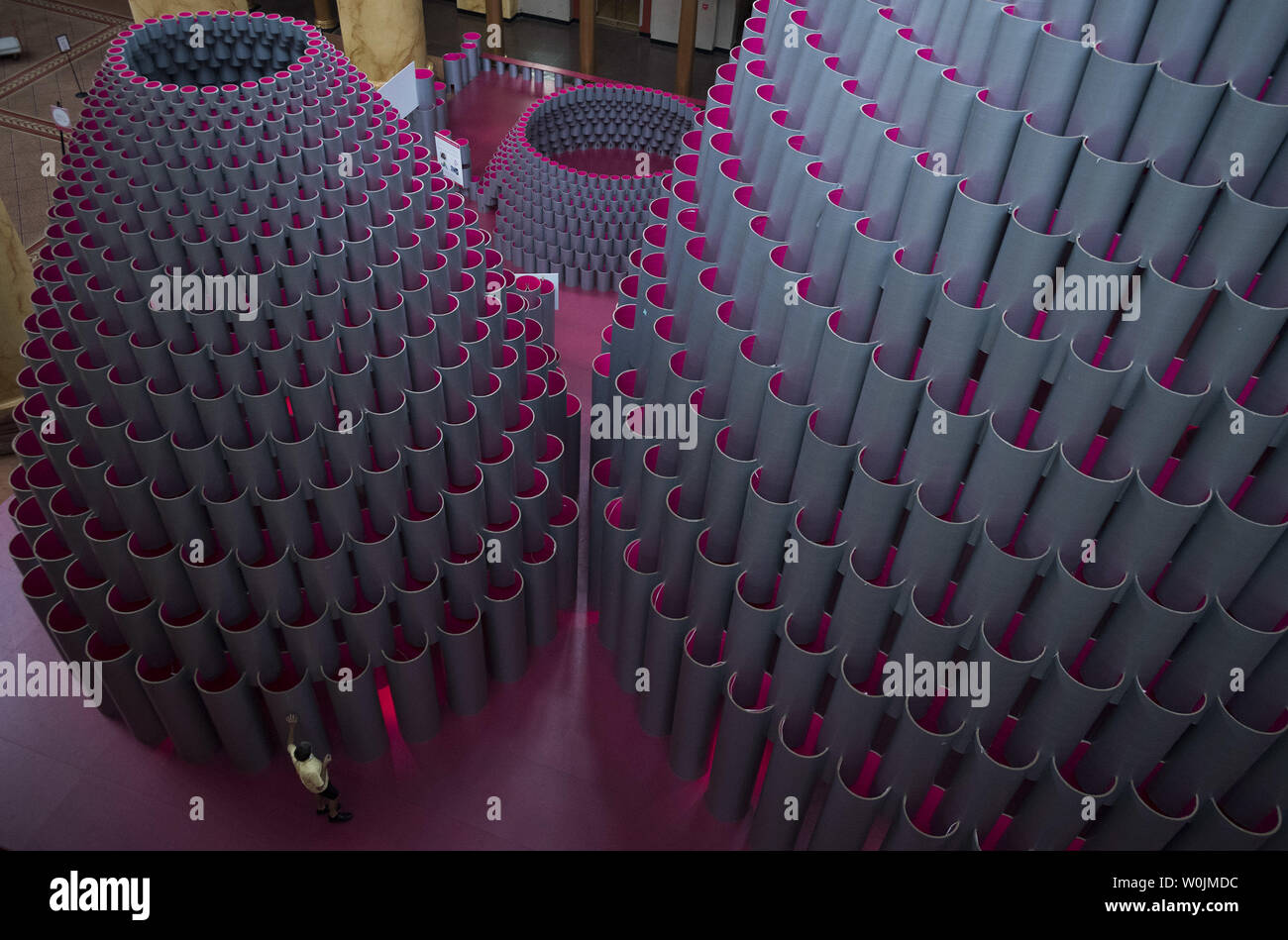 A man looks at an exhibit titled "Hive" is seen in the great hall at ...
