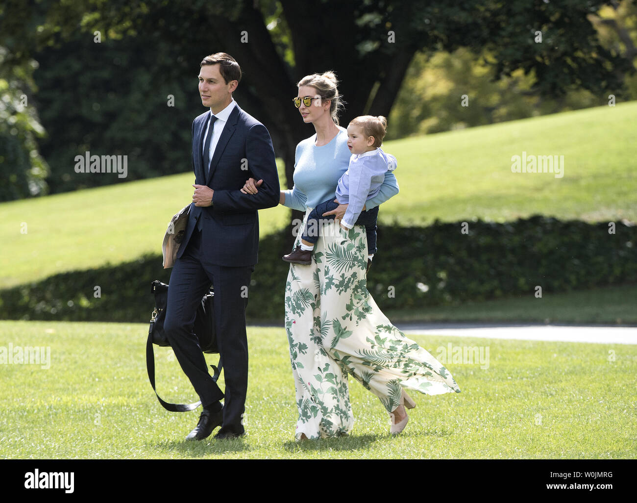 Ivanka Trump walks with her husband Jared Kushner as she holds their ...