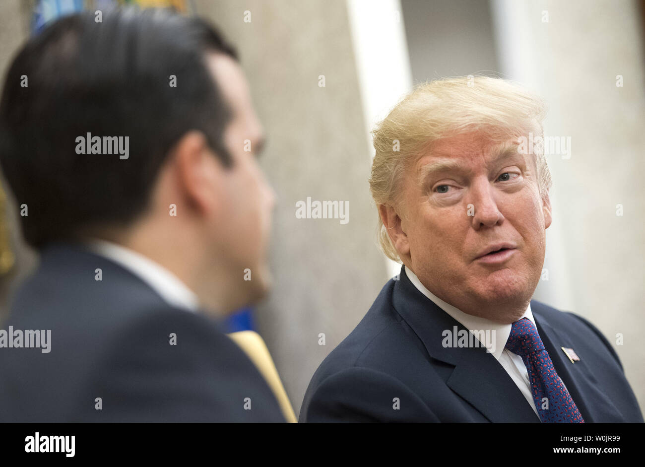 President Donald Trump speaks to the Governor Ricardo Rossello of ...