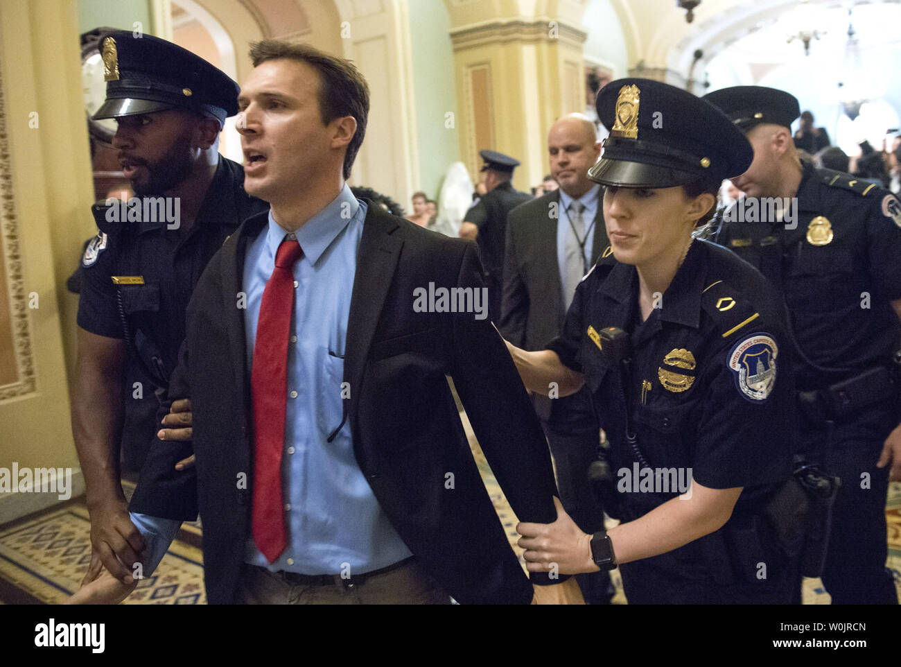 Ryan Clayton is arrested after throwing Russian flags at President ...