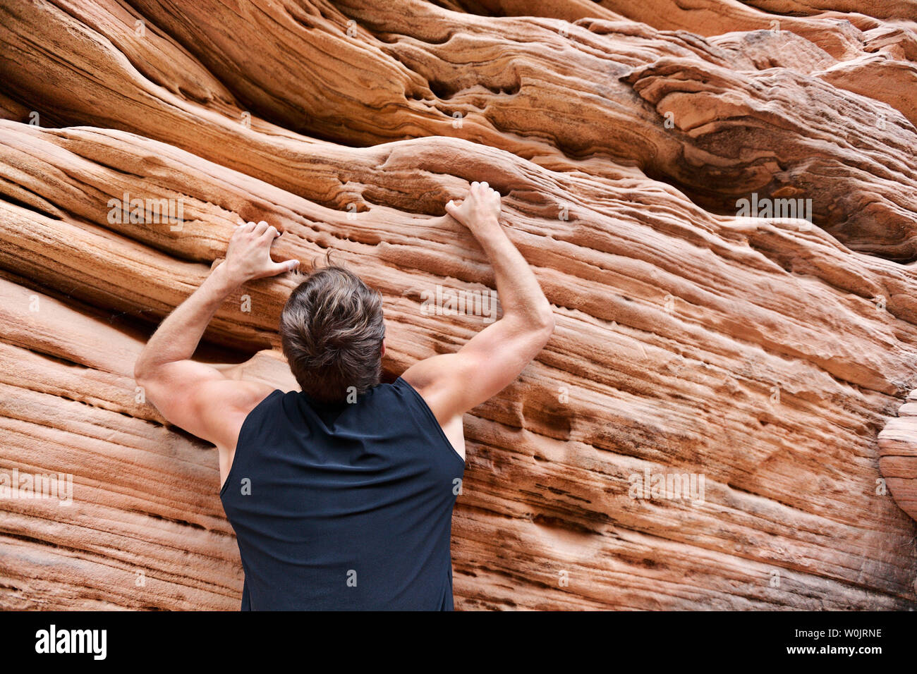 Climber man free climbing on rock. Male athlete on climb Stock Photo ...
