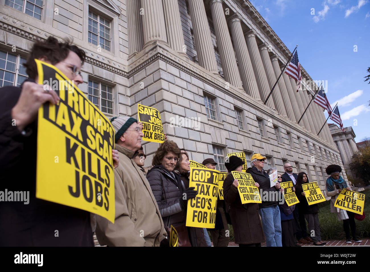 People protest during a rally against the Republican tax bill in front ...