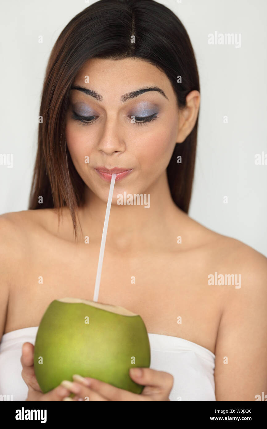 Close up of a woman drinking coconut water Stock Photo - Alamy