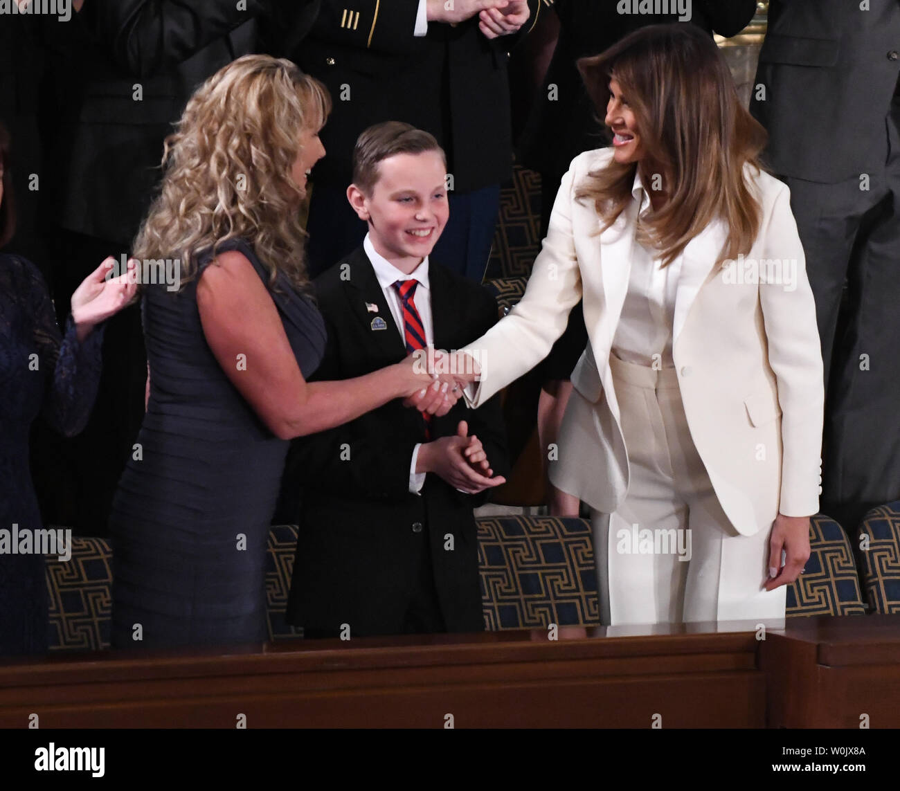 First Lady Melania Trump shakes hands with a guest as she arrives to ...