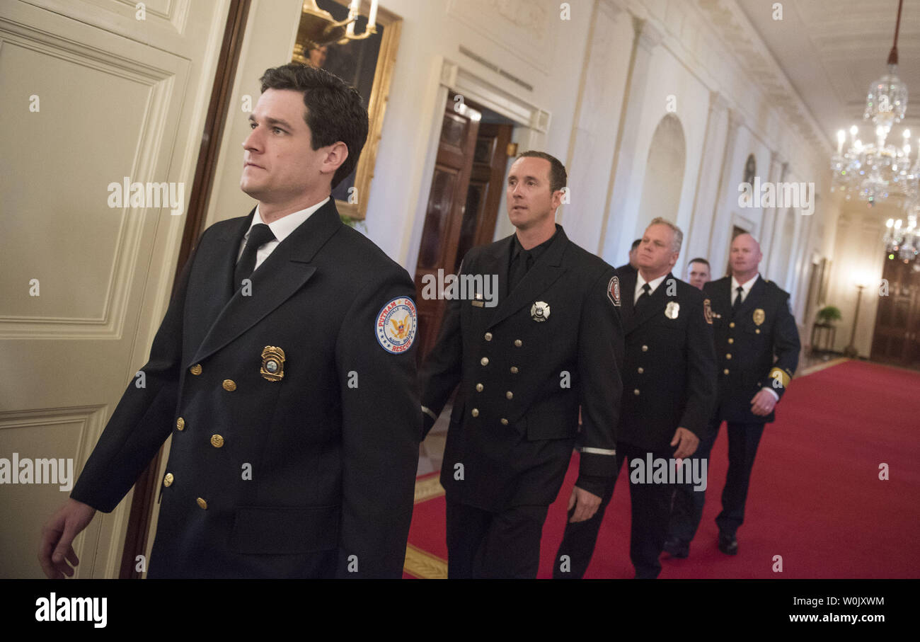Public Safety Medal of Valor Award recipients walk in to the East Room ...