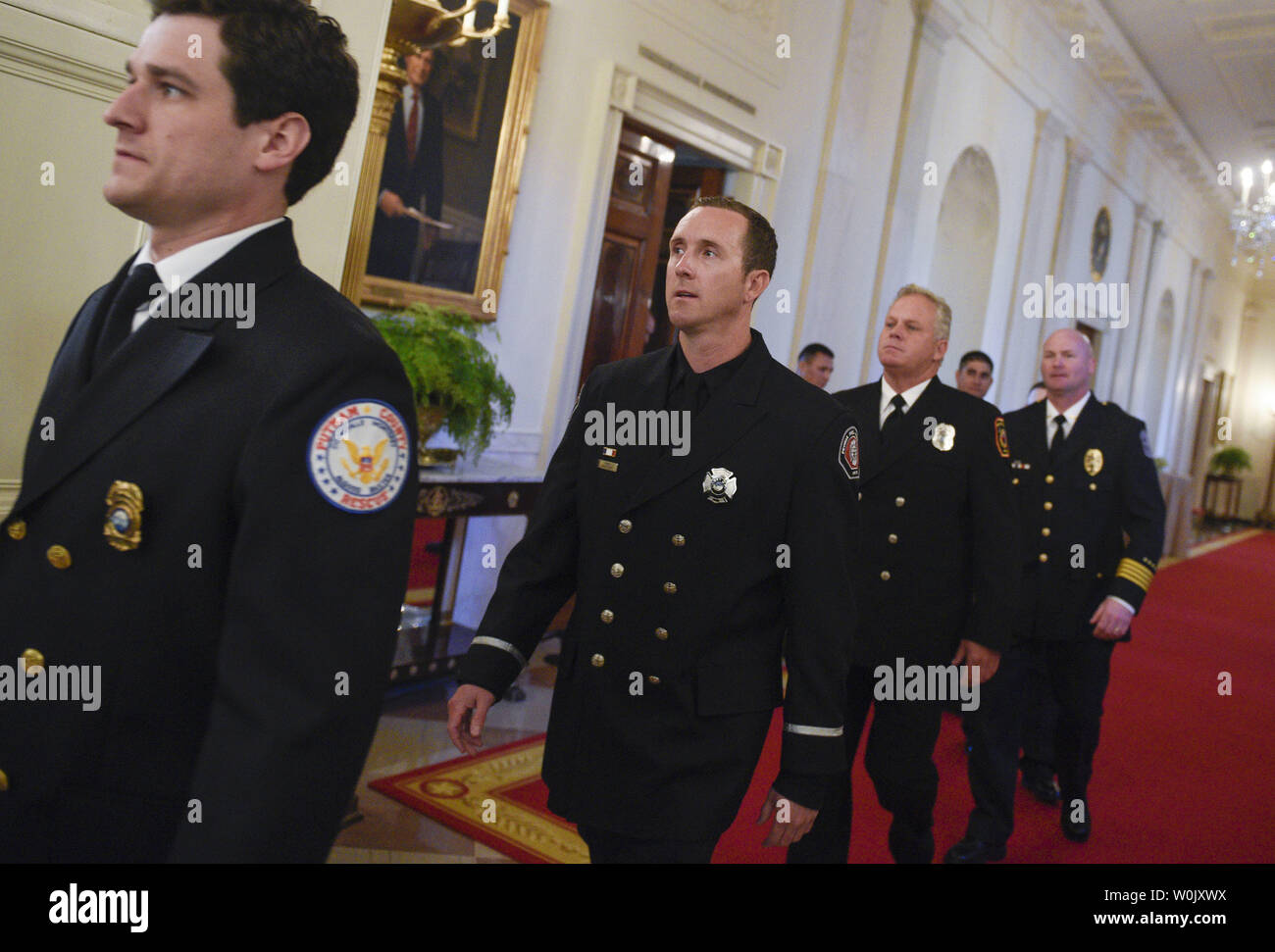 Public Safety Medal of Valor Award recipients walk in to the East Room ...