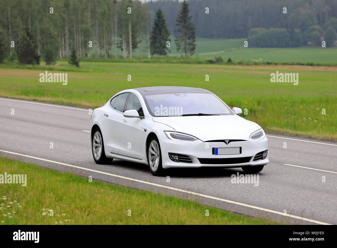 Salo, Finland. June 14, 2019. White Tesla Model S electric car driving ...