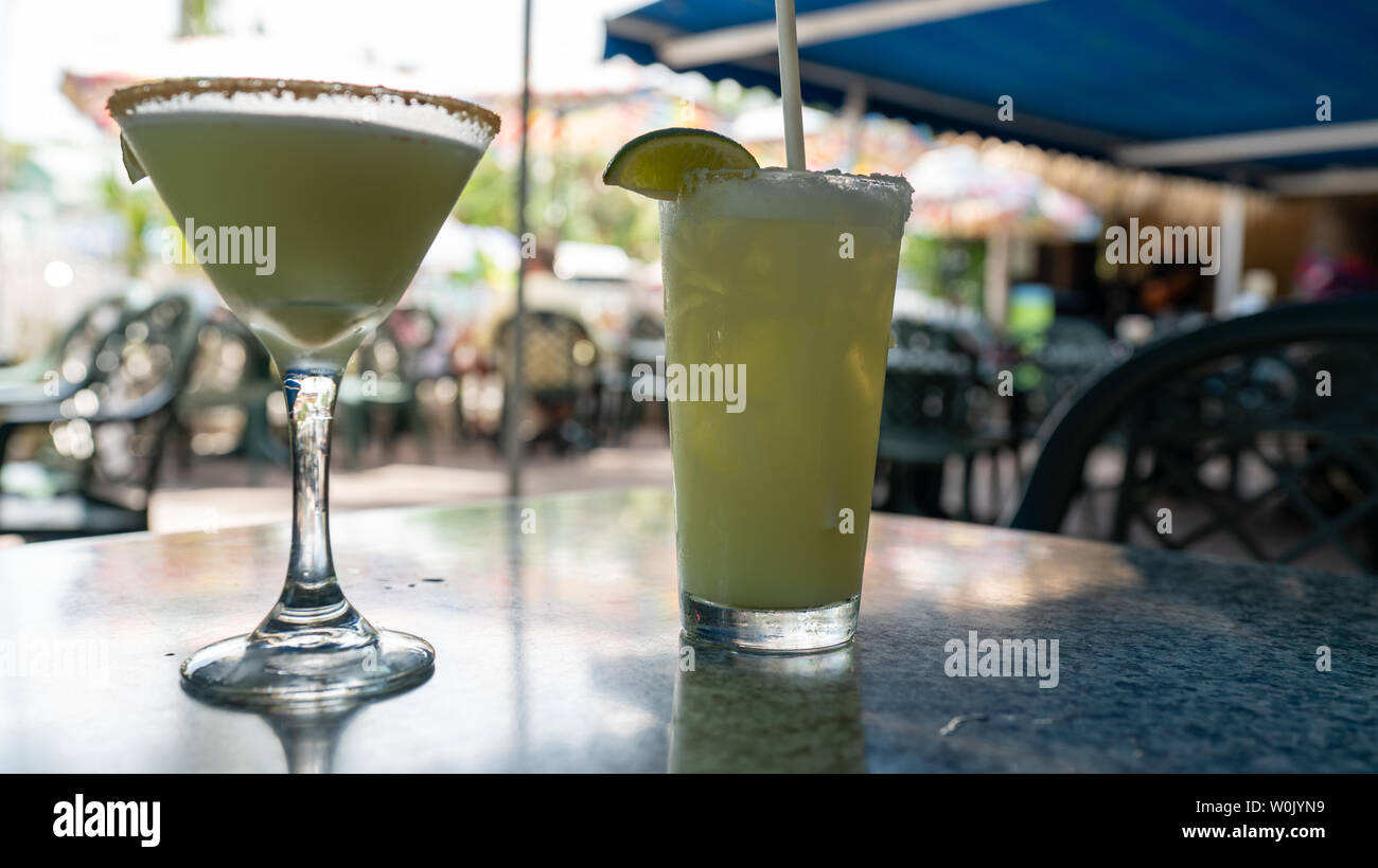 Two chilled tropical cocktails on a bar counter or table at a ...