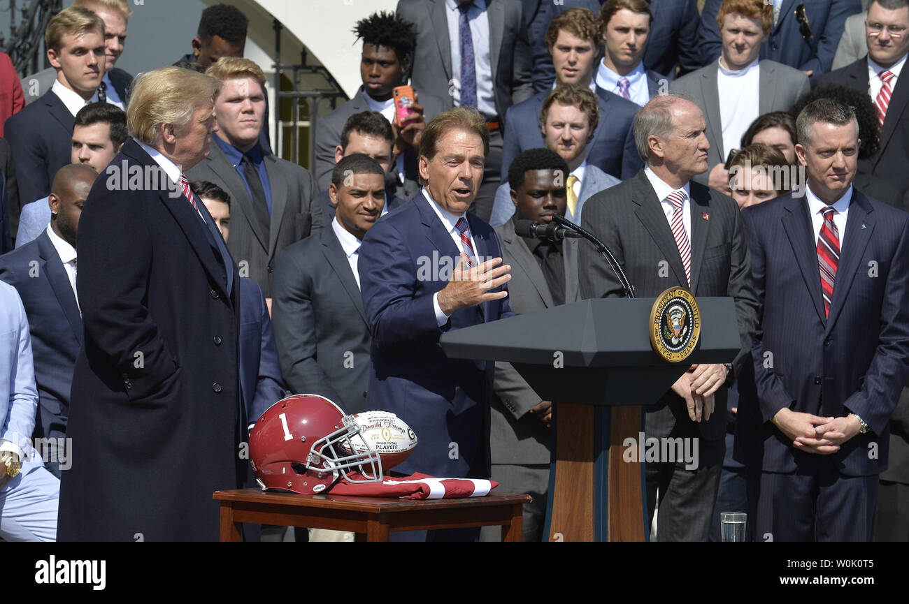 President Donald Trump (L) listens to remarks by University of Alabama ...