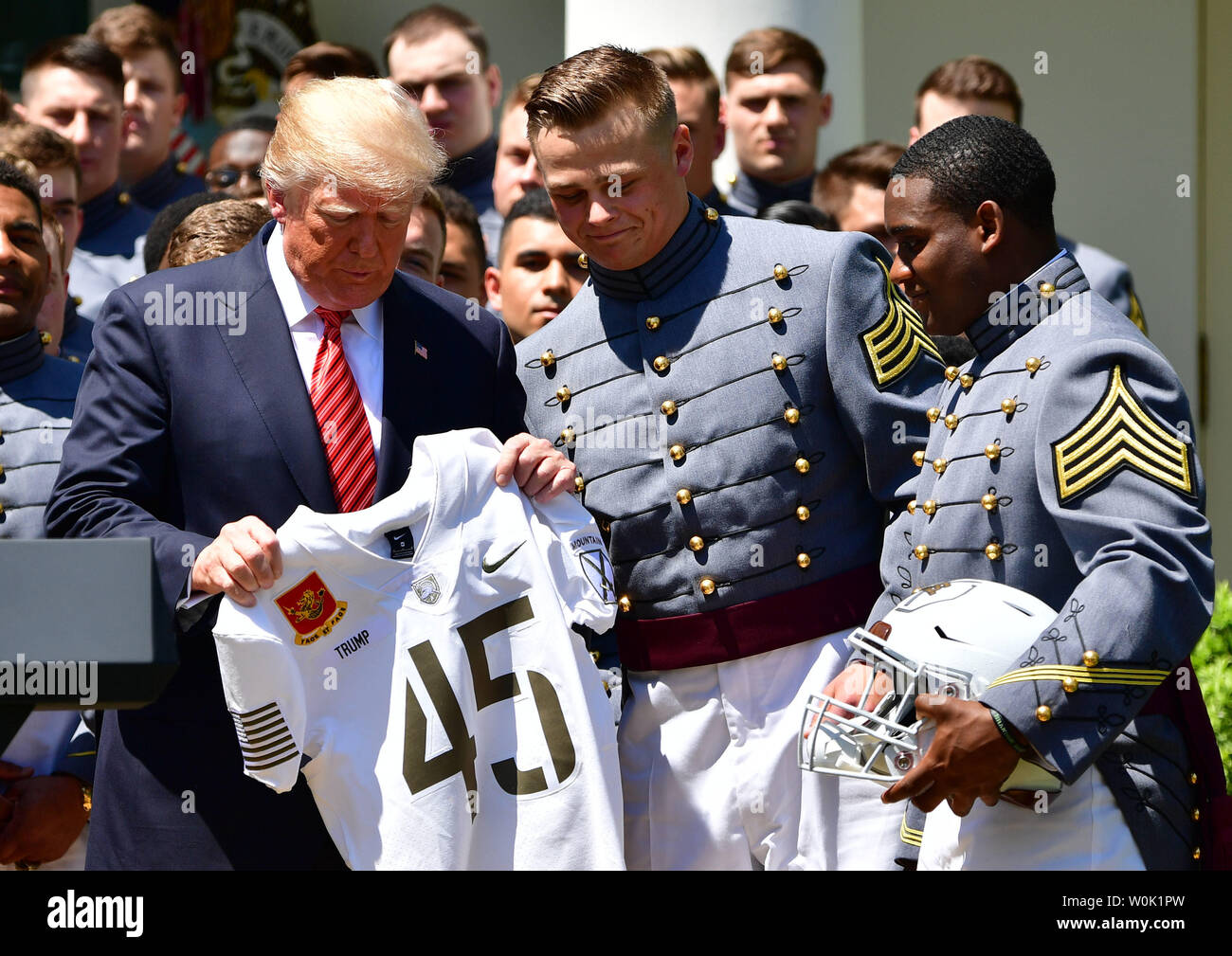 President Donald Trump receives a jersey from Army Black Nights team ...