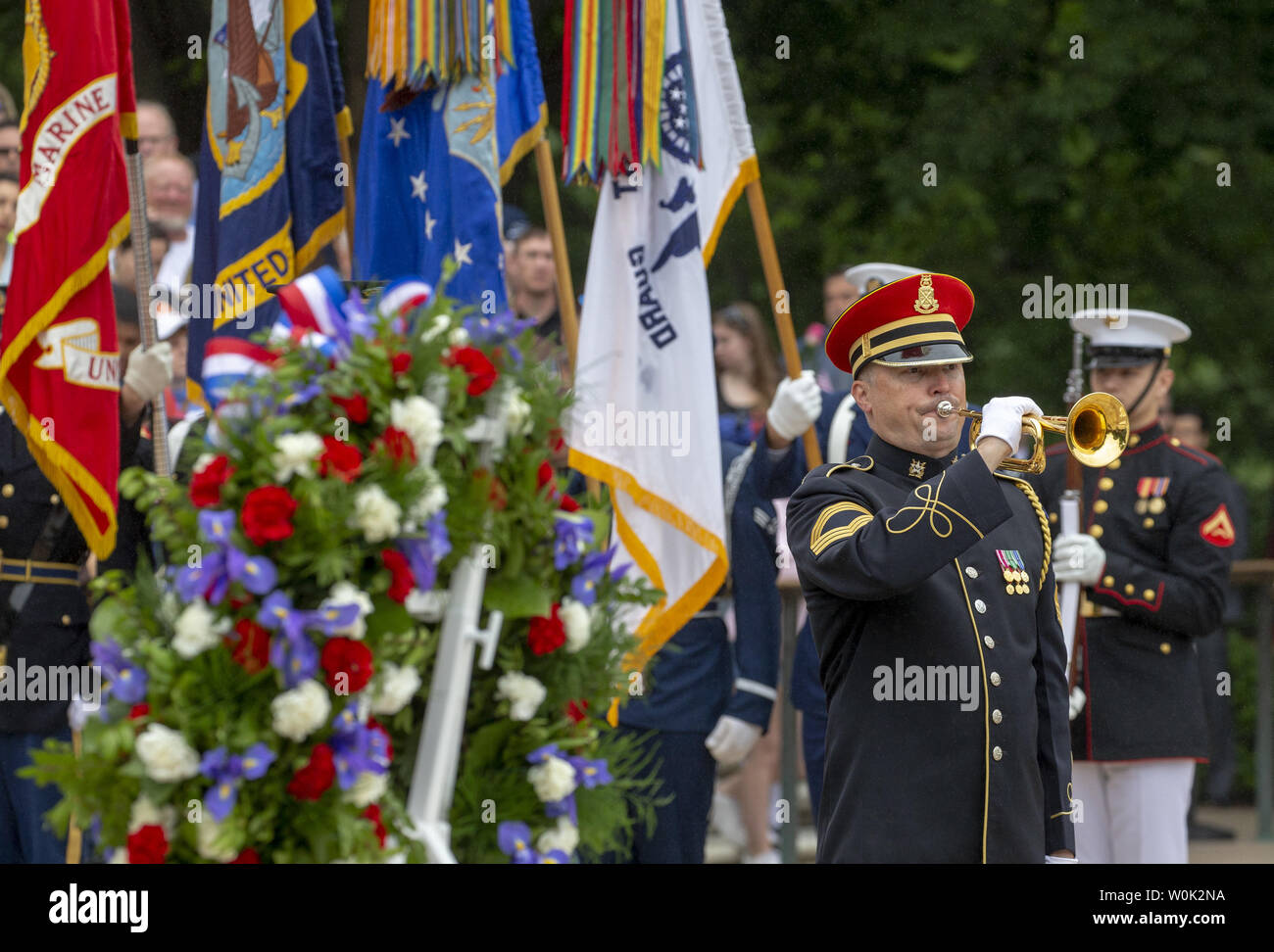 A bugler plays taps during a wreath laying ceremony at the Tomb of the ...
