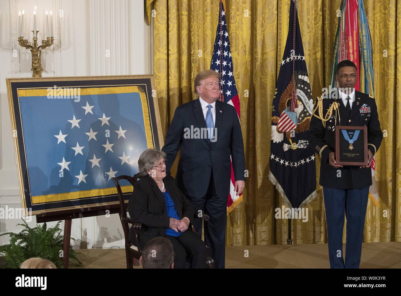 President Donald Trump stands with Pauline Lyda Wells Conner the widow ...