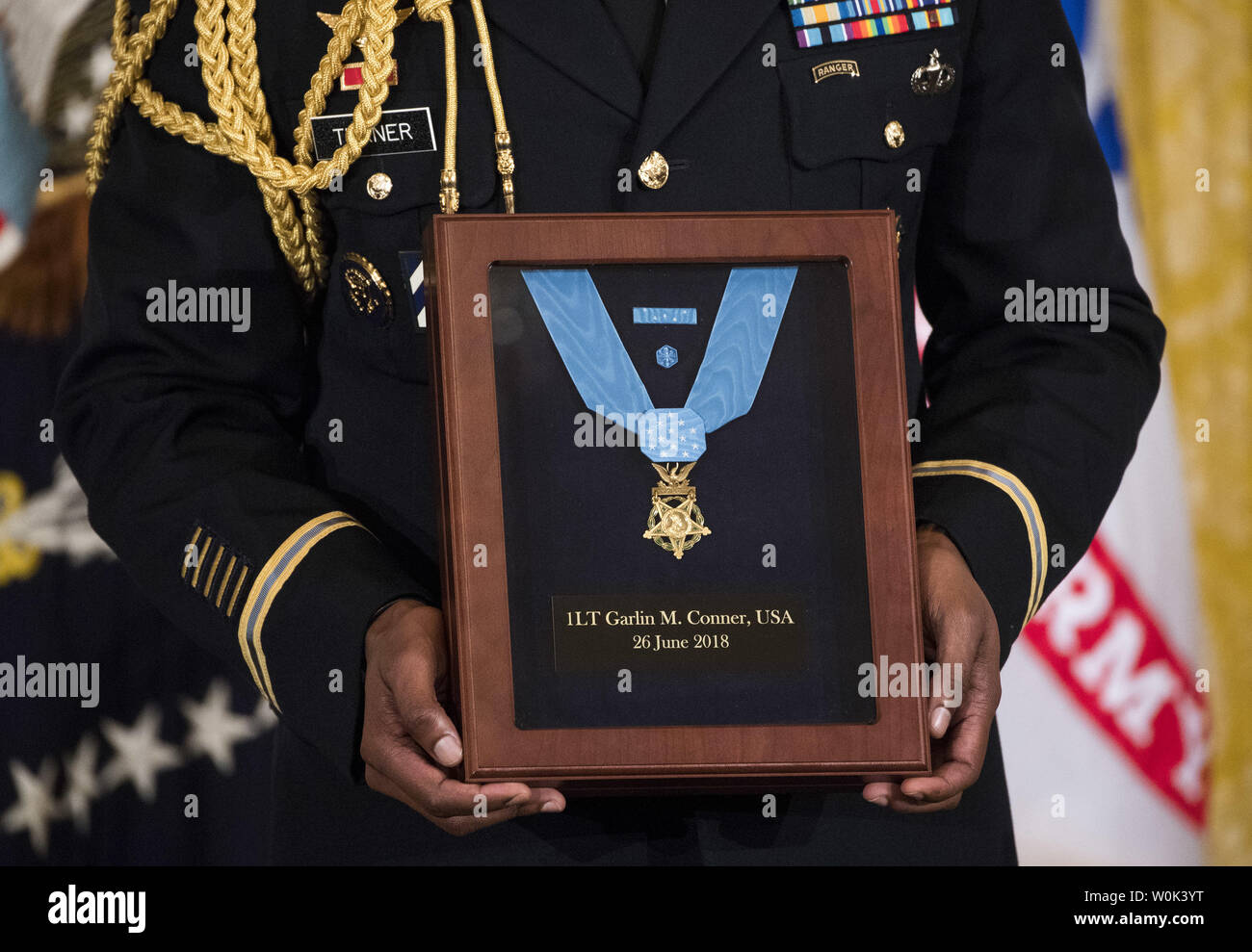 A military aid holds the Medal of Honor President Donald Trump ...