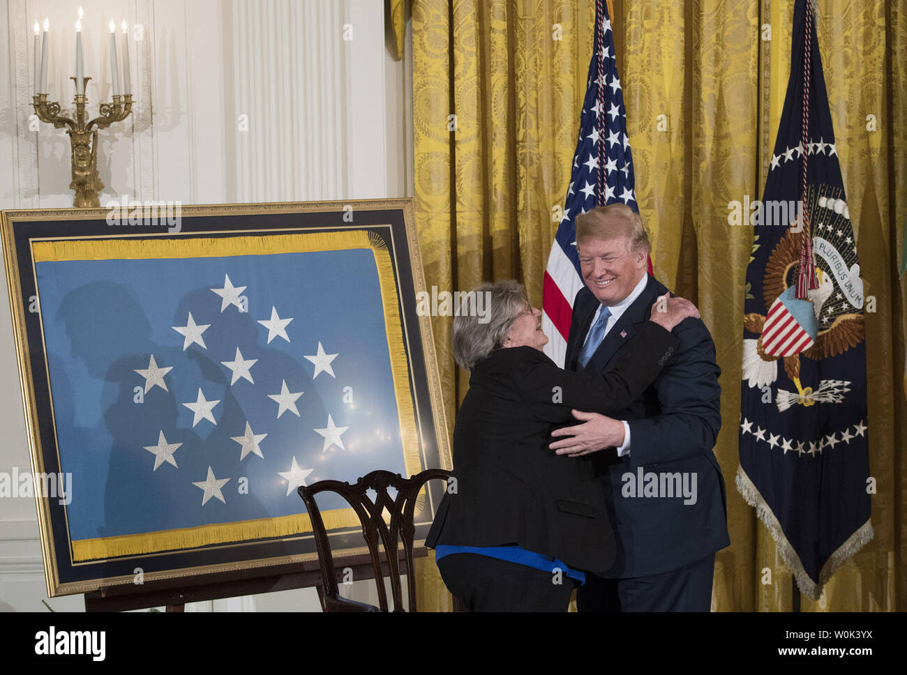 President Donald Trump hugs Pauline Lyda Wells Conner the widow of Army ...
