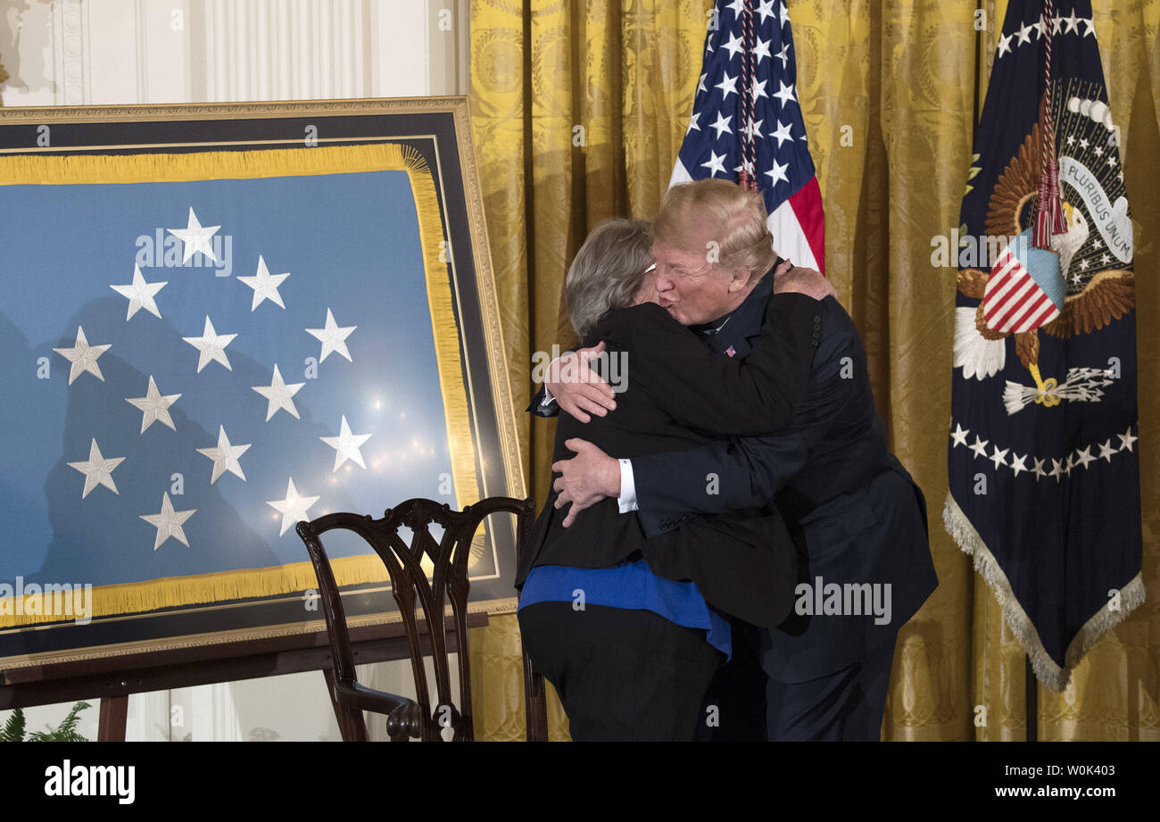 President Donald Trump hugs Pauline Lyda Wells Conner the widow of Army ...
