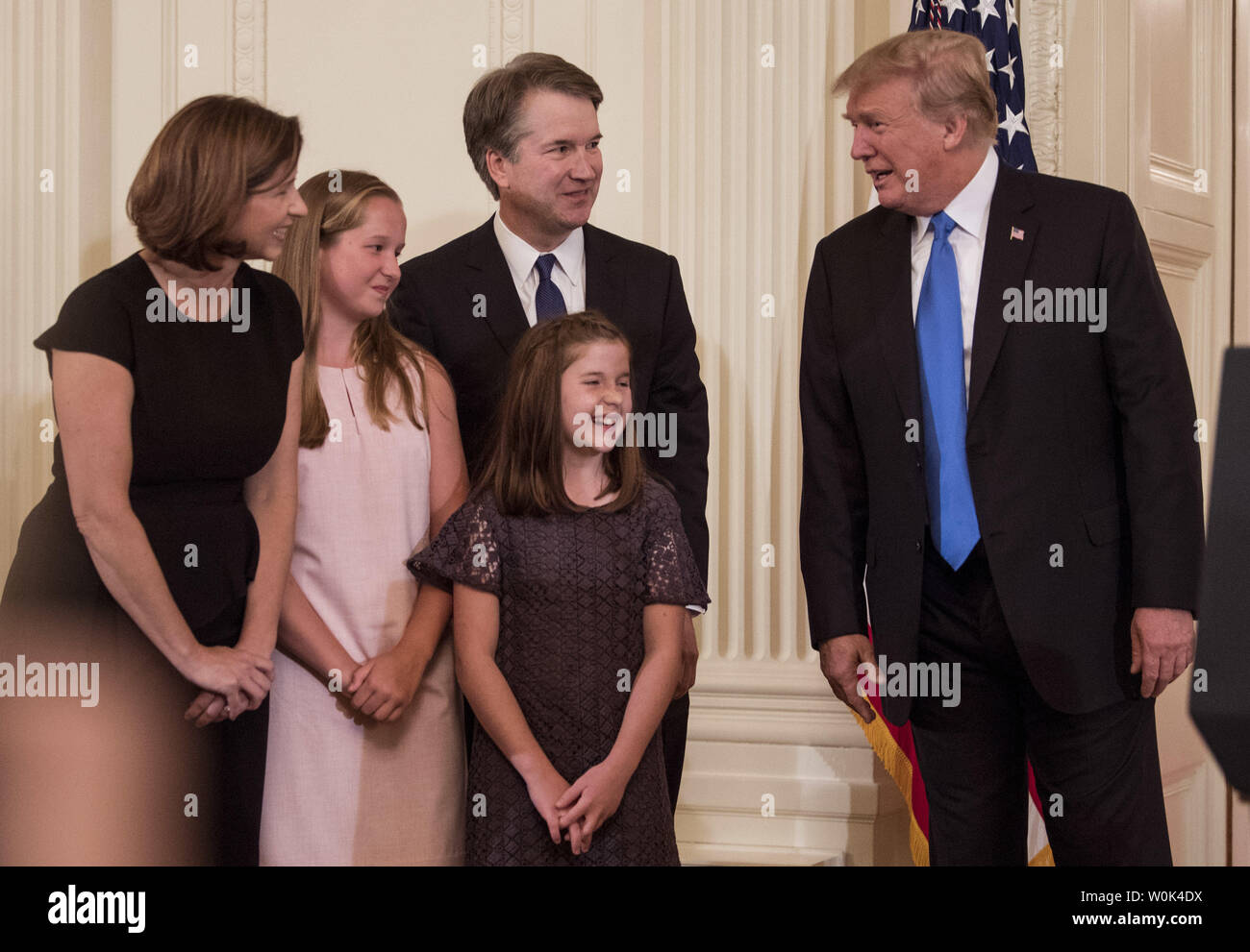 President Trump leans in to talk to Brett Kavanaugh, his nominee to be ...