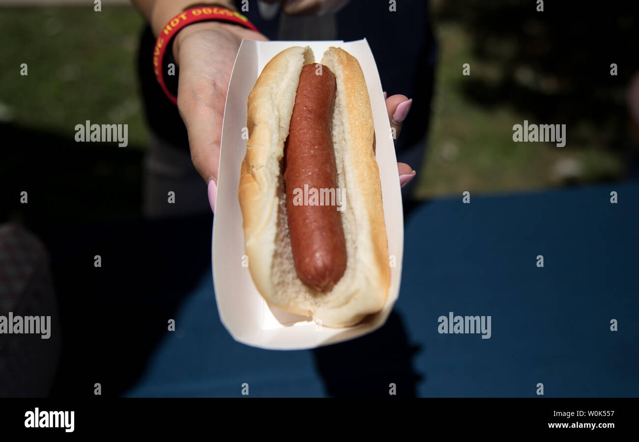 A volunteer offers a hot dog at the Congressional Hot Dog Lunch ...