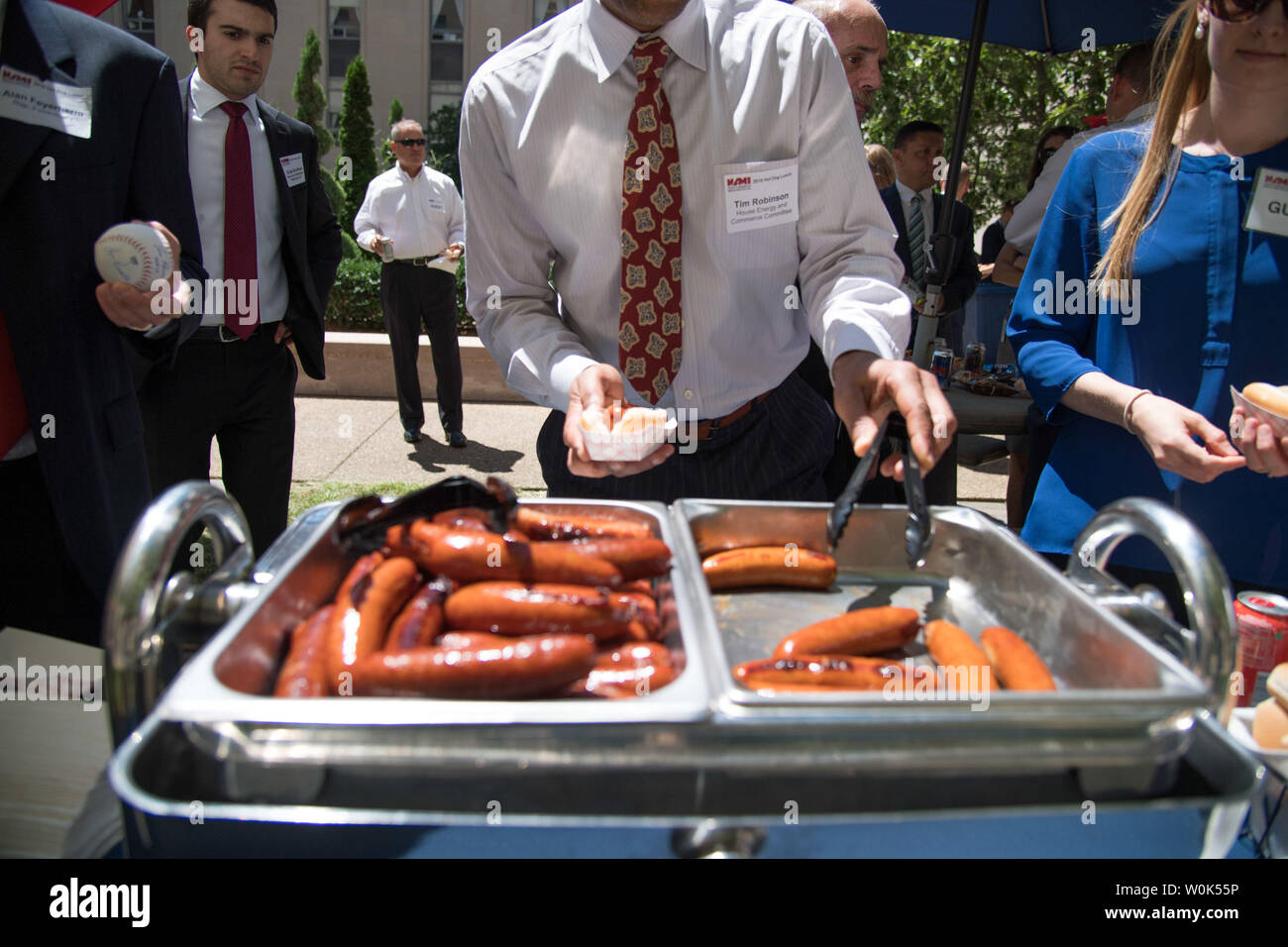 A participant takes a hot dog at the Congressional Hot Dog Lunch ...
