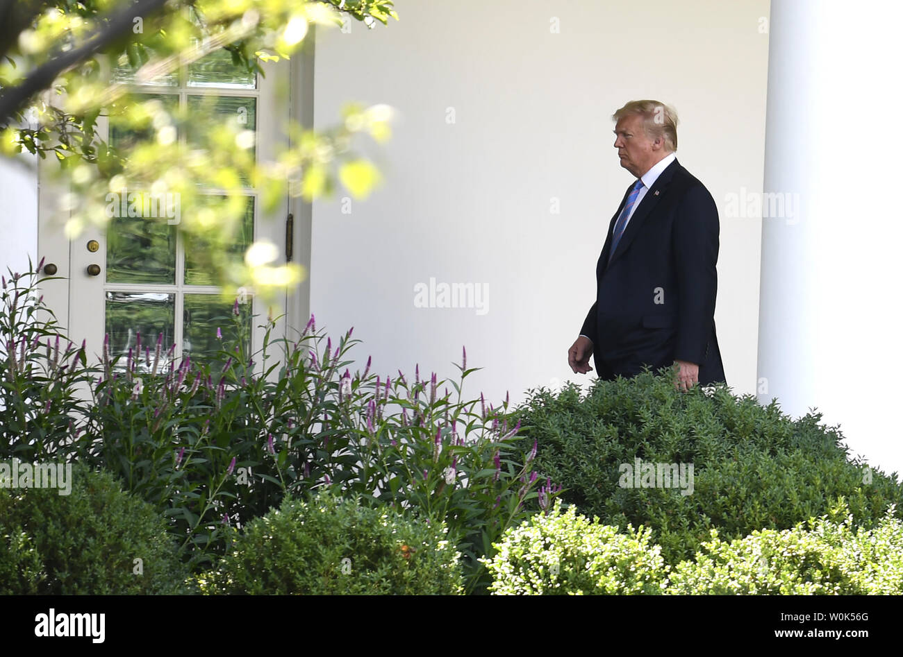 President Donald Trump walks to the West Wing after returning to the ...