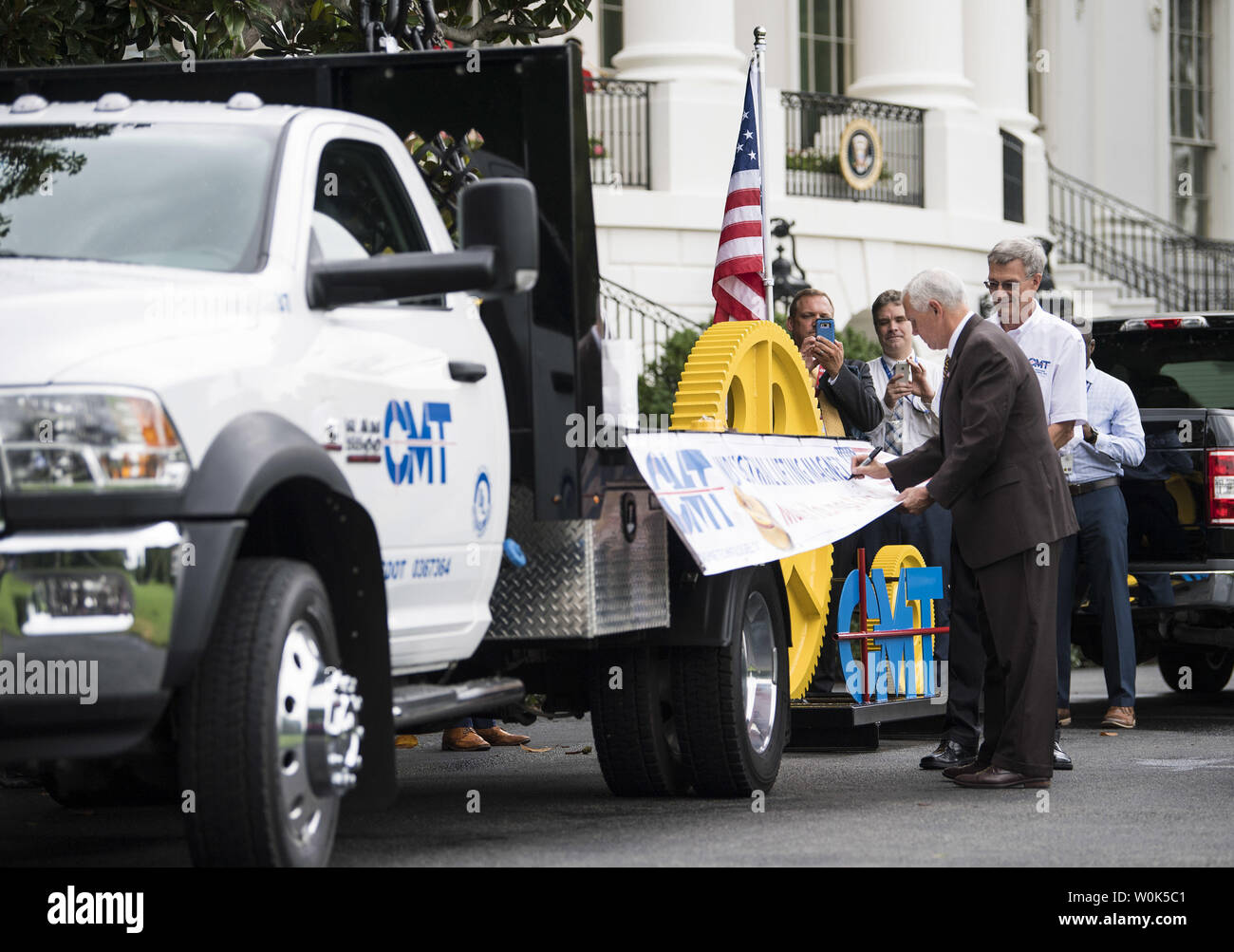 Vice President Mike Pence sign a banner while visiting with ...