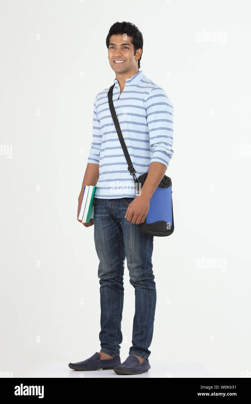 College student standing and smiling Stock Photo - Alamy