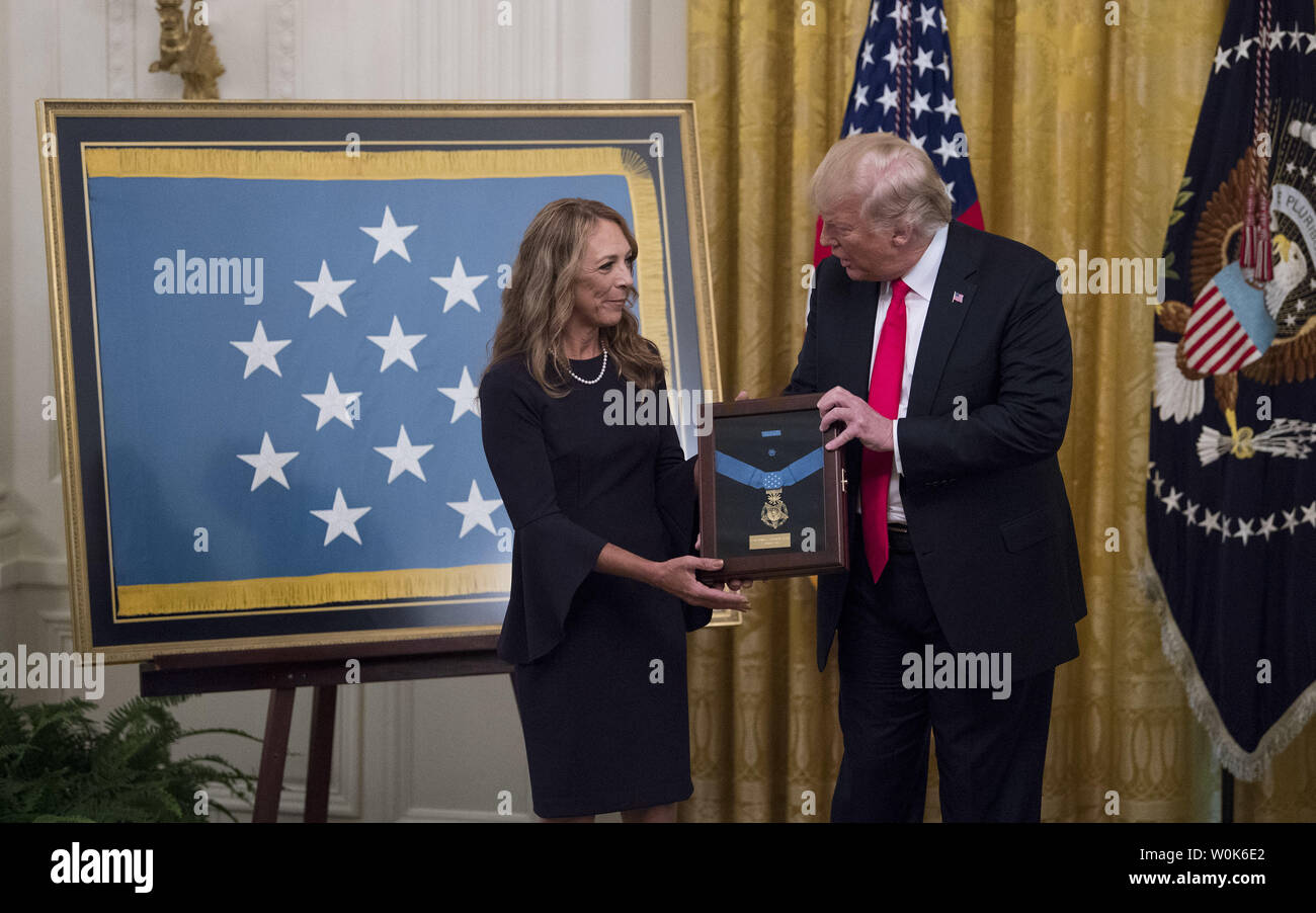 President Donald Trump presents Valerie Chapman, the widow of Air Force Tech Sgt. John Chapman ...