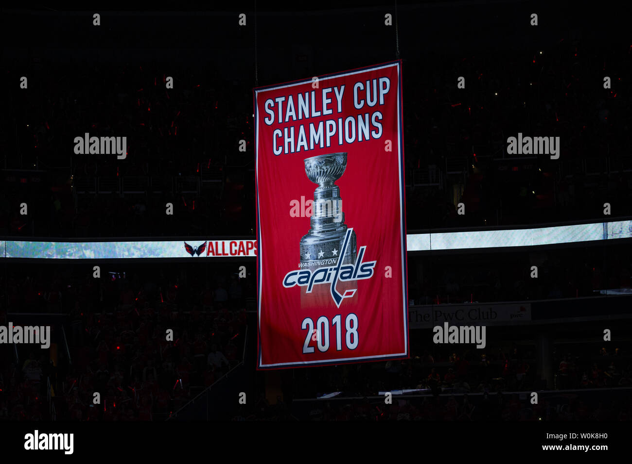 Washington Capitals players look on as the 2018 Stanley Cup Banner is ...