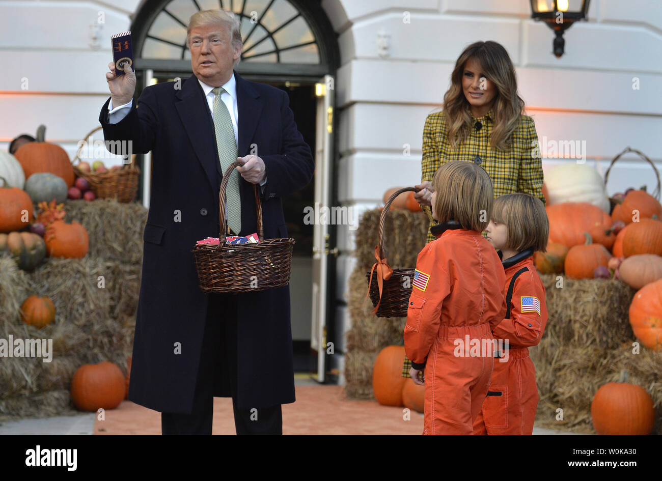 President Donald Trump holds up a candy bar as he and First Lady ...
