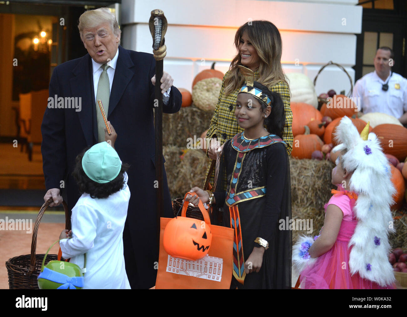 President Donald Trump holds up a staff with a cobra on it as he and ...