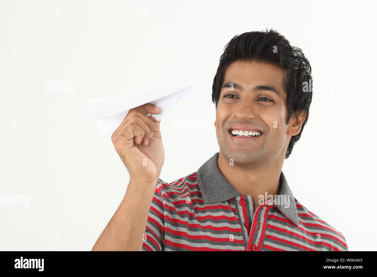 Man playing with paper airplane Stock Photo - Alamy