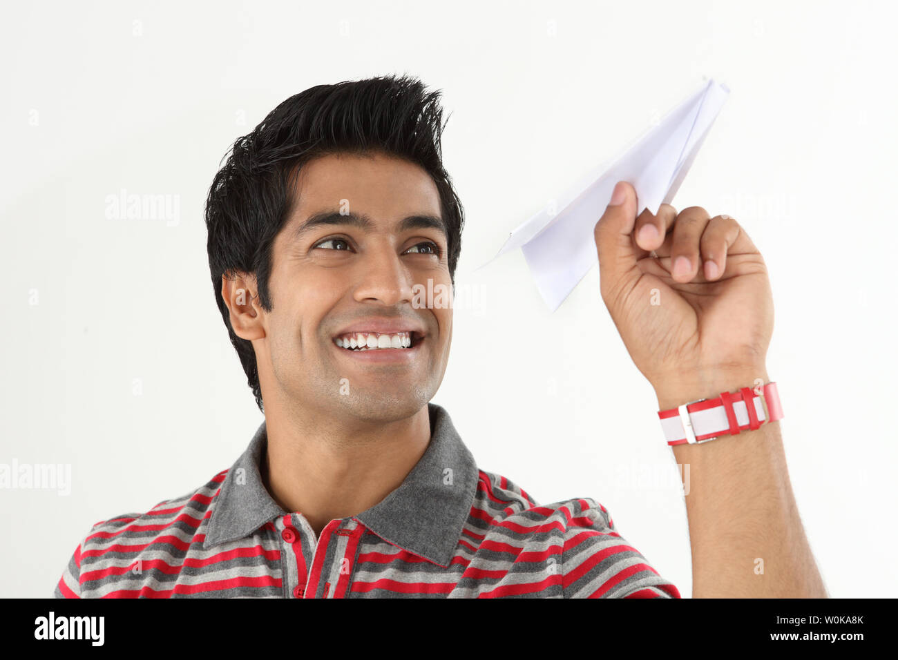 Indian man playing with paper airplane Stock Photo - Alamy