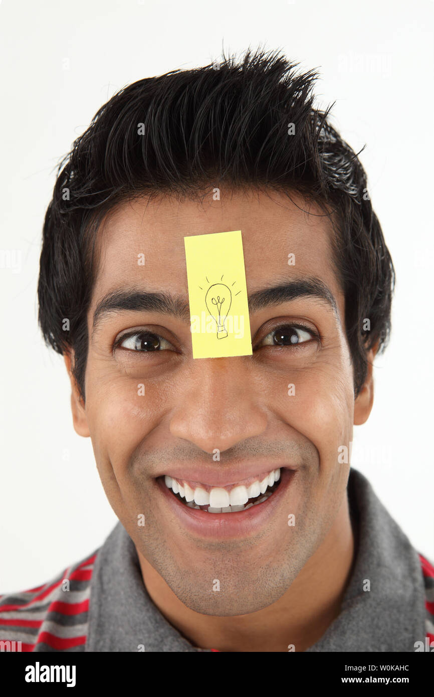 Man with an adhesive note on his forehead Stock Photo - Alamy