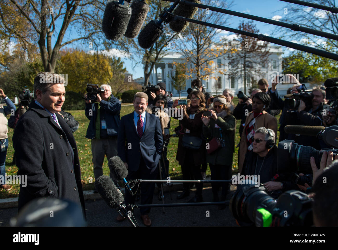 CNN reporter Jim Acosta (L) enters the White House grounds after having ...
