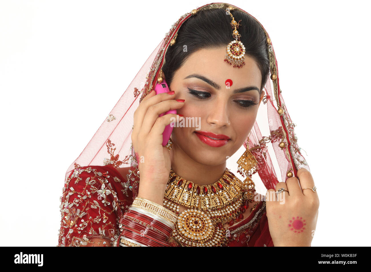 Close up of an Indian bride talking on a mobile phone Stock Photo - Alamy