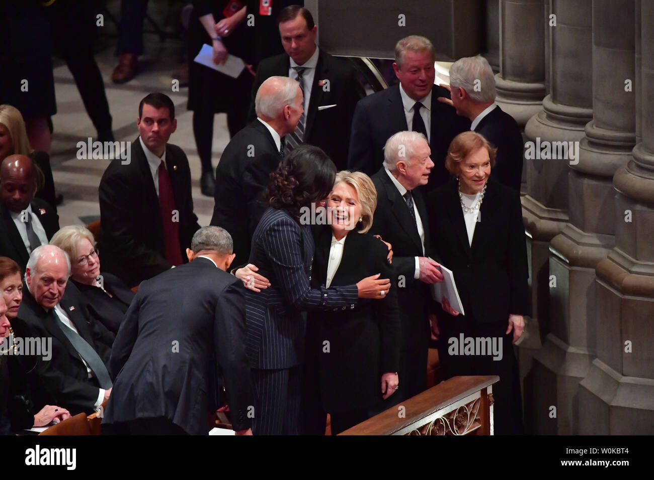 Hillary Clinton hugs Michelle Obama as former presidents and spouses ...