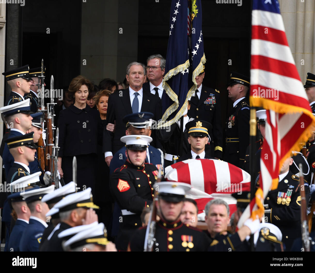 The casket of President George Herbert Walker Bush is followed out of ...