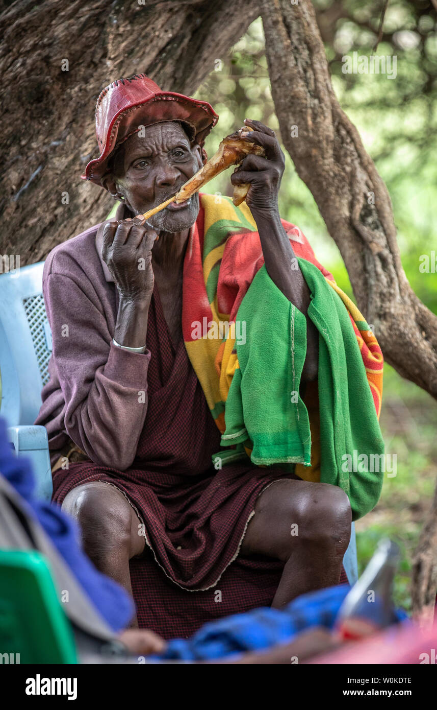 same, Tanzania, 5th June 2019: old man chewing on a bone Stock Photo ...