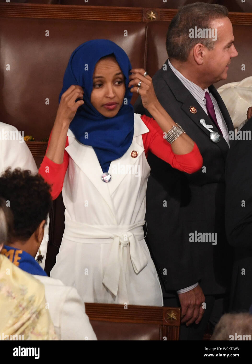Rep. Ilhan Omar (D-MN), adjusts her hajib as she arrives wearing white ...