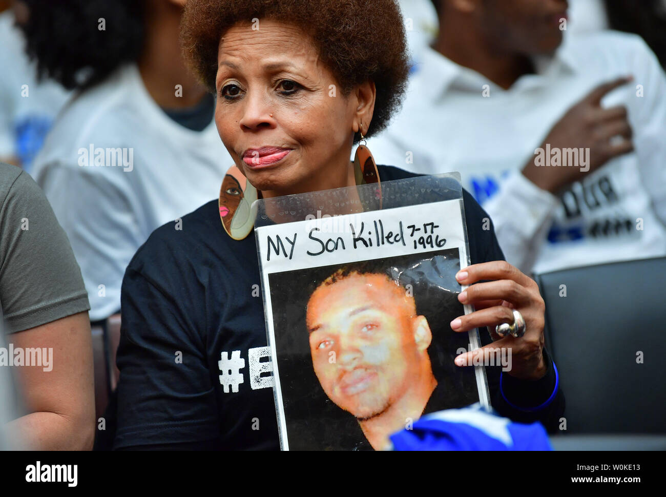 Mattie Scott, holds a photo of her son George Scott, who died in a ...