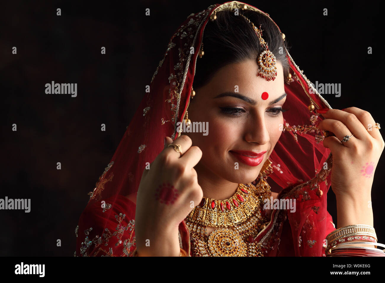 Indian bride holding veil hi-res stock photography and images - Alamy