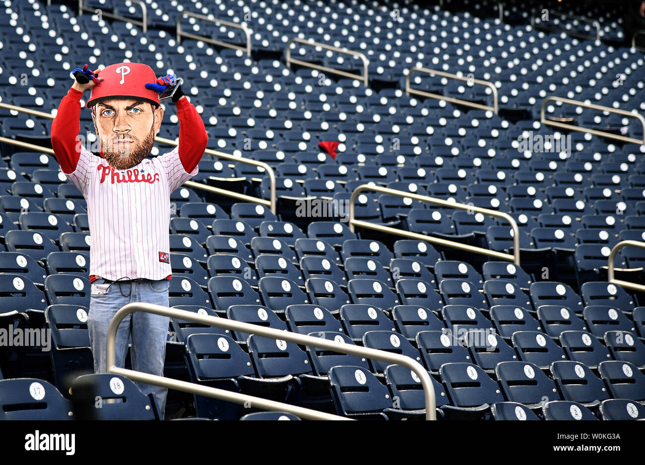 A Philadelphia Phillies fan adjusts a Bryce Harper mask as he arrives ...