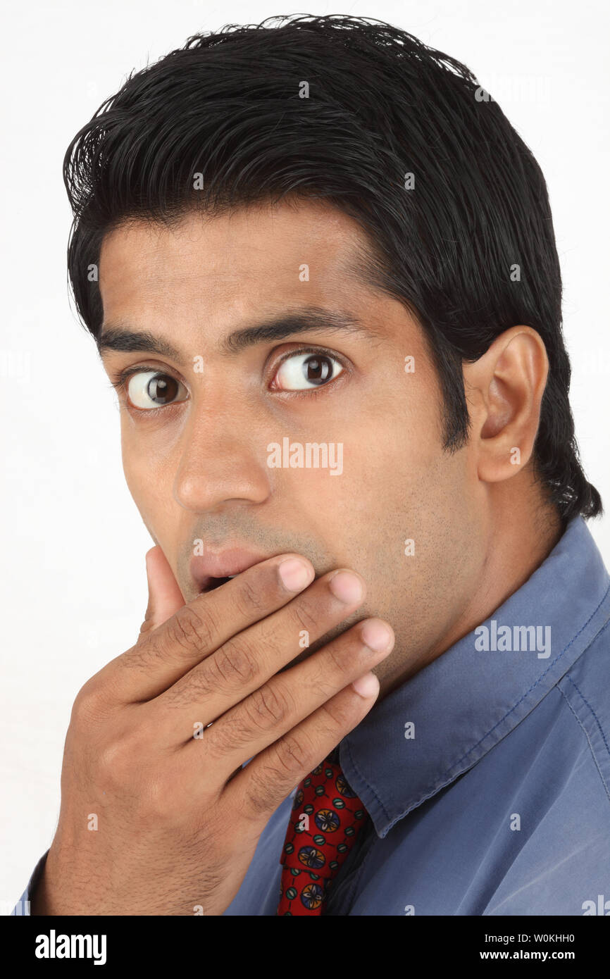 Indian young businessman looking shocked Stock Photo - Alamy