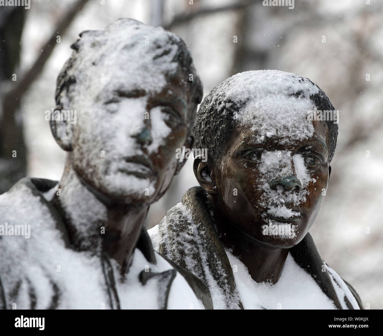 Snow covers statues near the Vietnam Memorial in Washington on March 2 ...