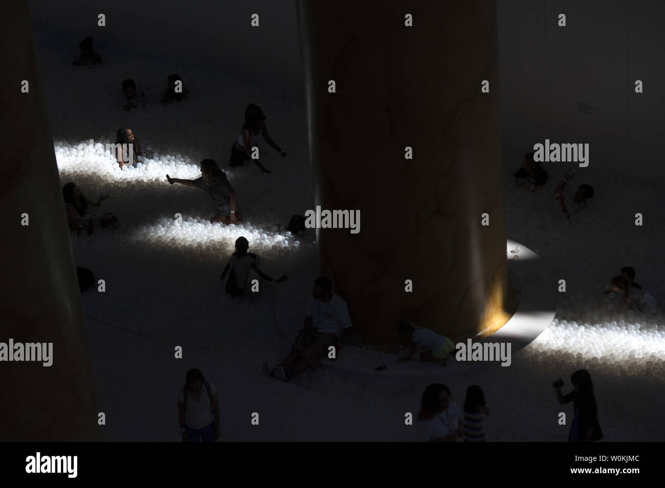 Visitors play in a pit of balls at the BEACH exhibit at the National ...