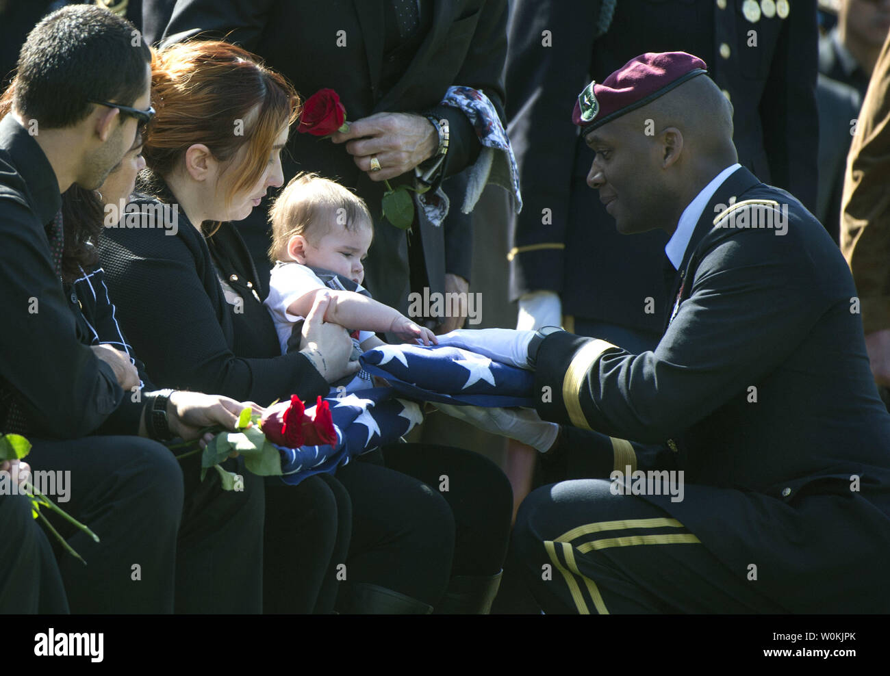 Brig. Gen. Xavier Brunson presents a flag to Declan McClintock, son of ...